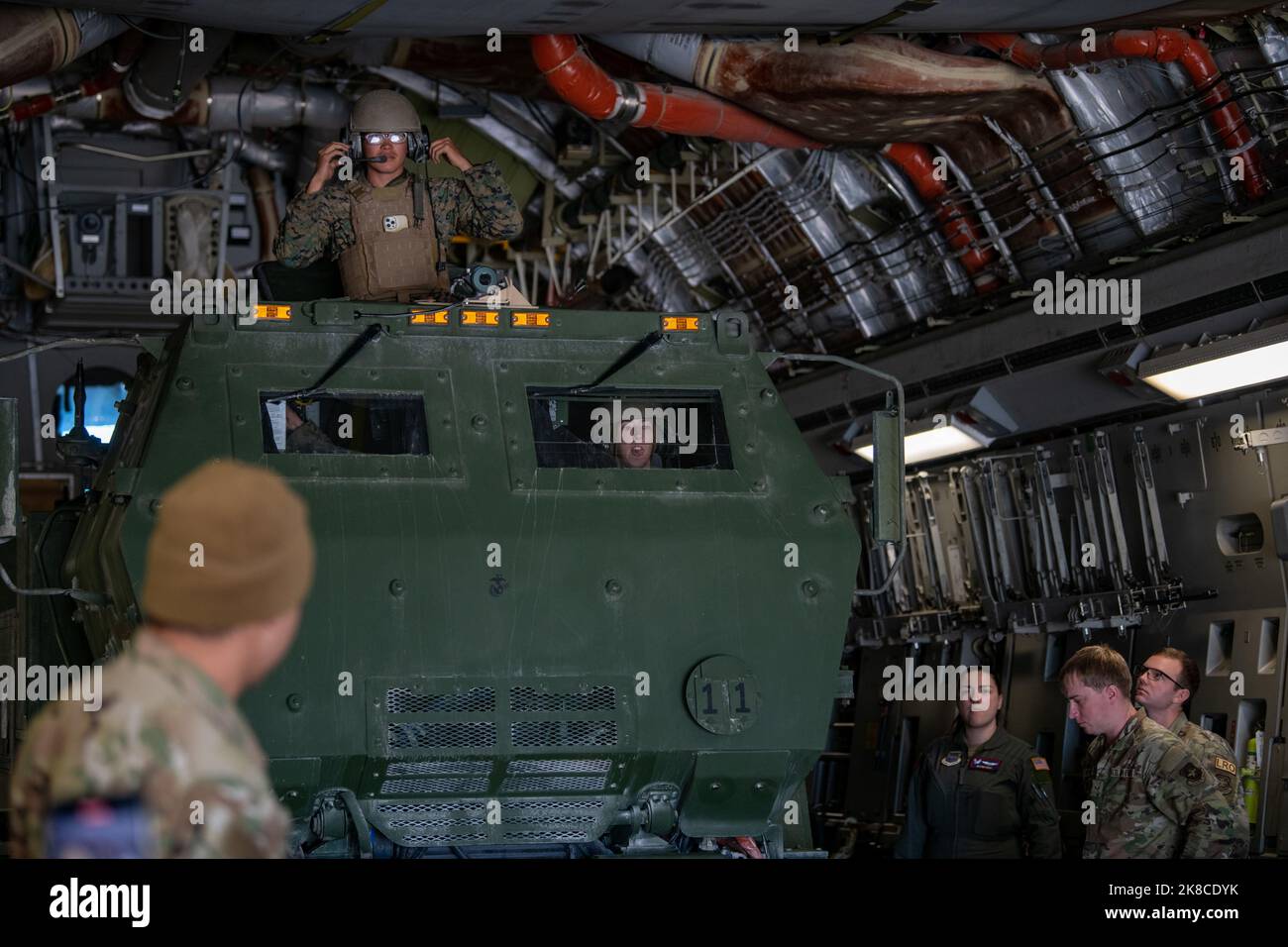 U.S. service members off-load a High Mobility Artillery Rocket System ...