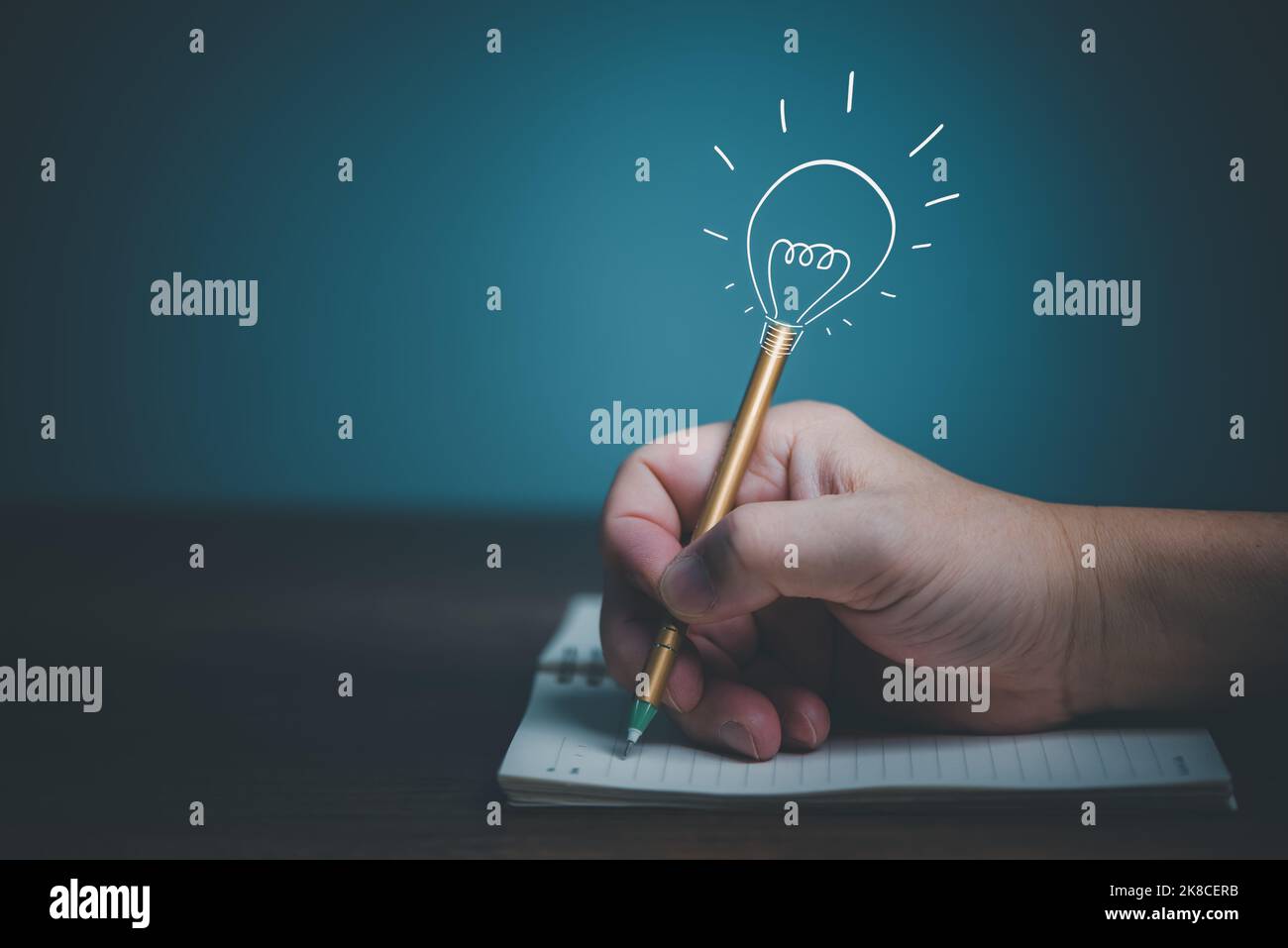Hand holding a pen writing down on a notebook and document with copy ...