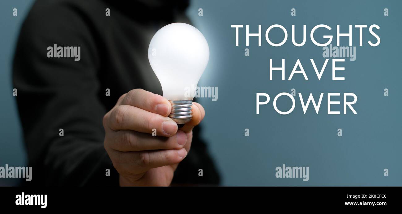 Hand holding light bulb with text Thoughts Have Power, The power of ...