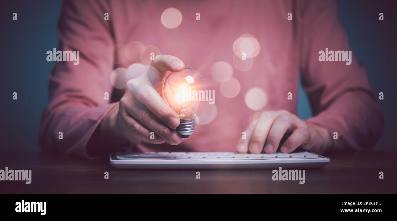 Hand touching on Light bulb glowing bright bulb and texting on the ...