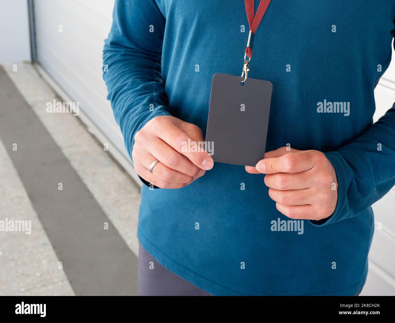 Man with badge near garage. Close up photo of hands with clear black ...