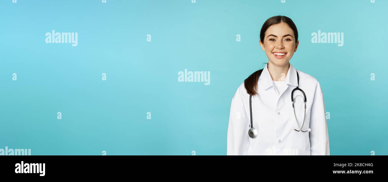 Smiling healthy medical worker, young woman doctor looking happy ...