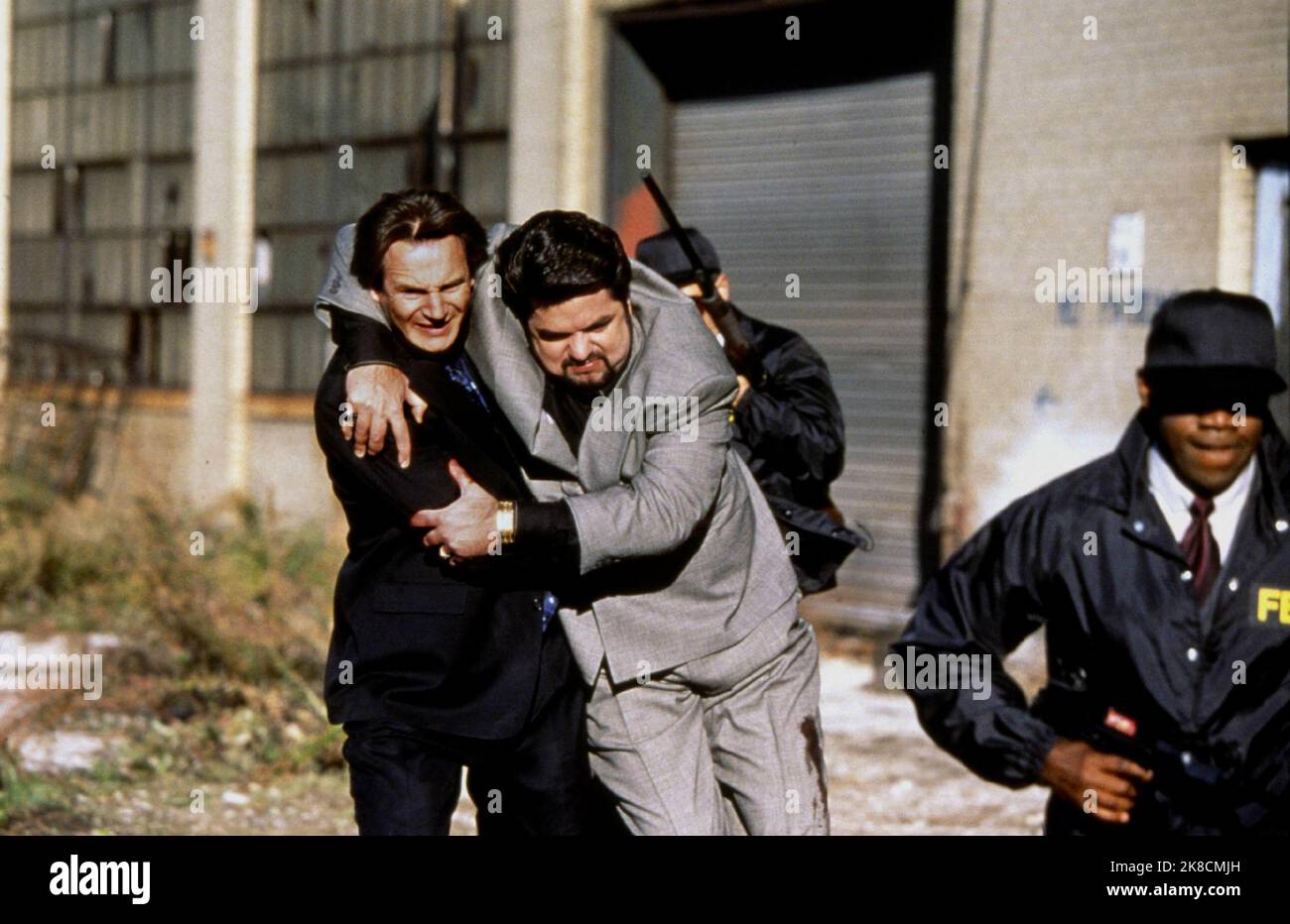 Liam Neeson & Oliver Platt Film: Gun Shy (2000) Characters: Charles 'Charlie' Mayeaux & Fulvio ...