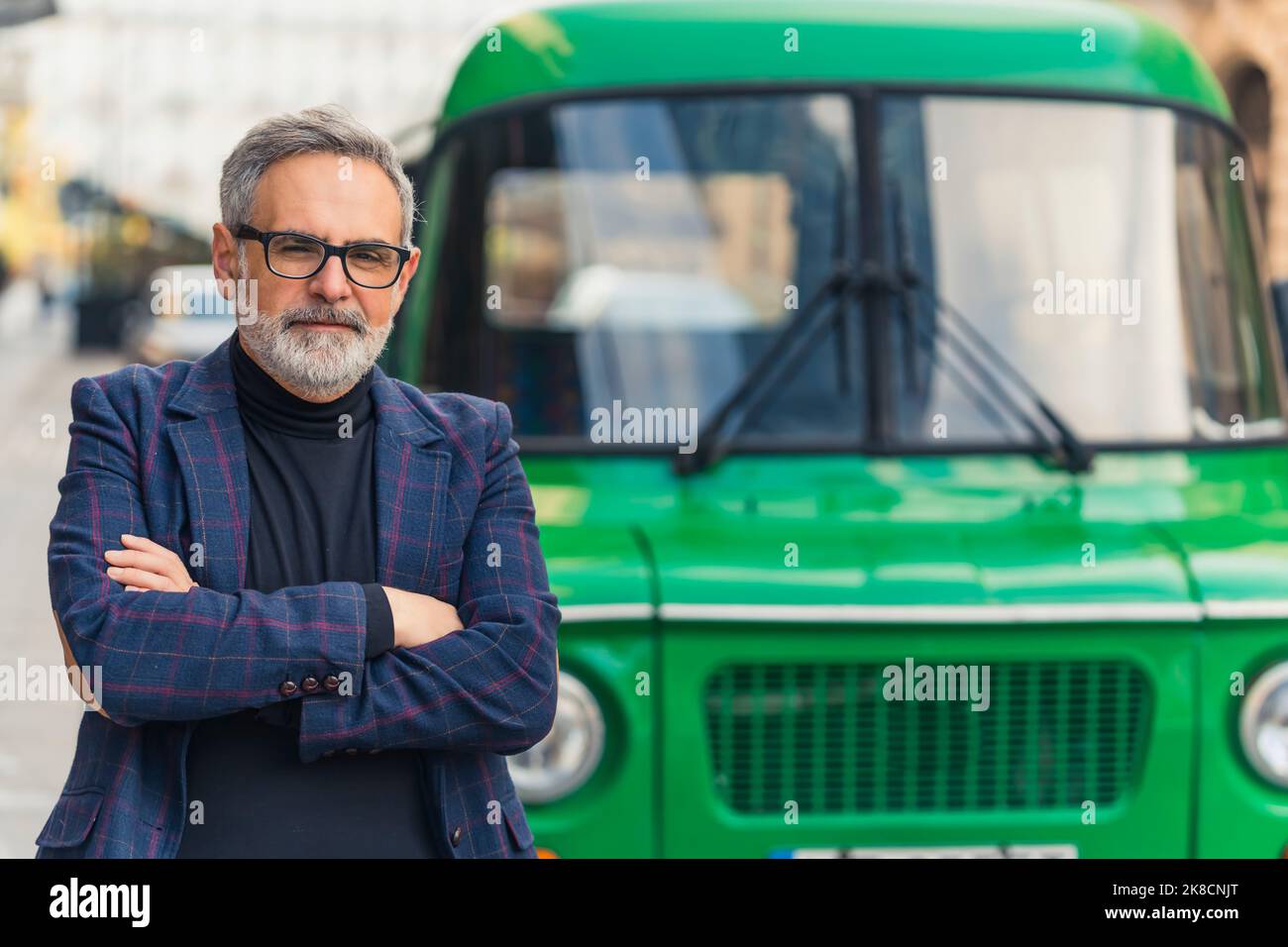 Confident, middle-aged, bearded, grey-haired man in a blazer and a ...