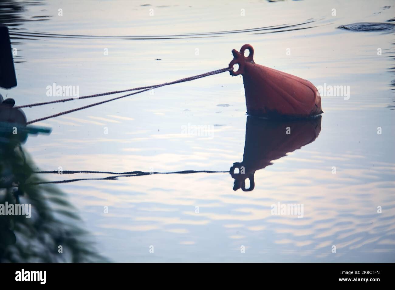 Buoy floating on the water and its reflection casted below it Stock ...
