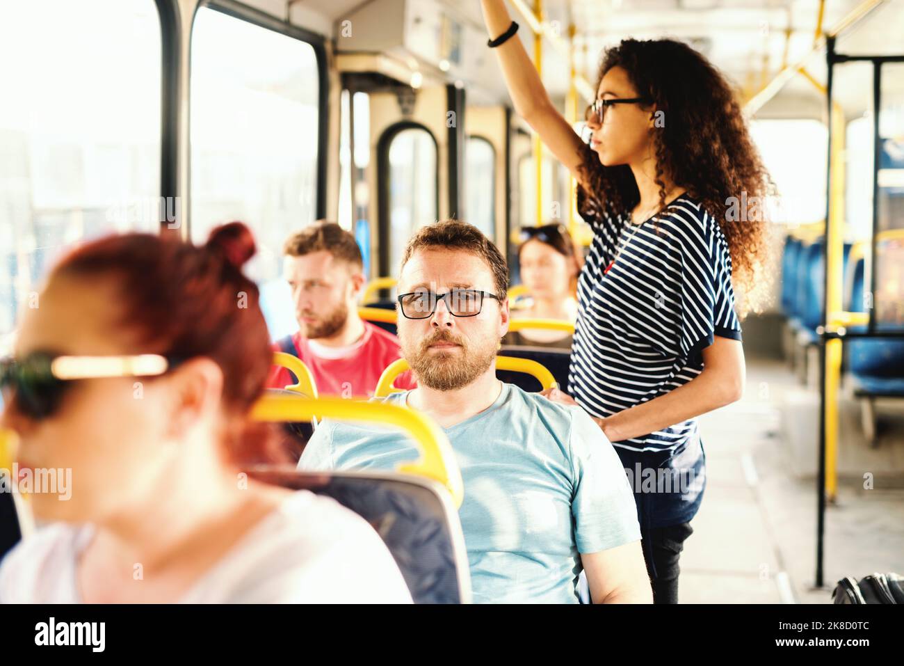 Multicultural group of people riding in the city bus Stock Photo - Alamy