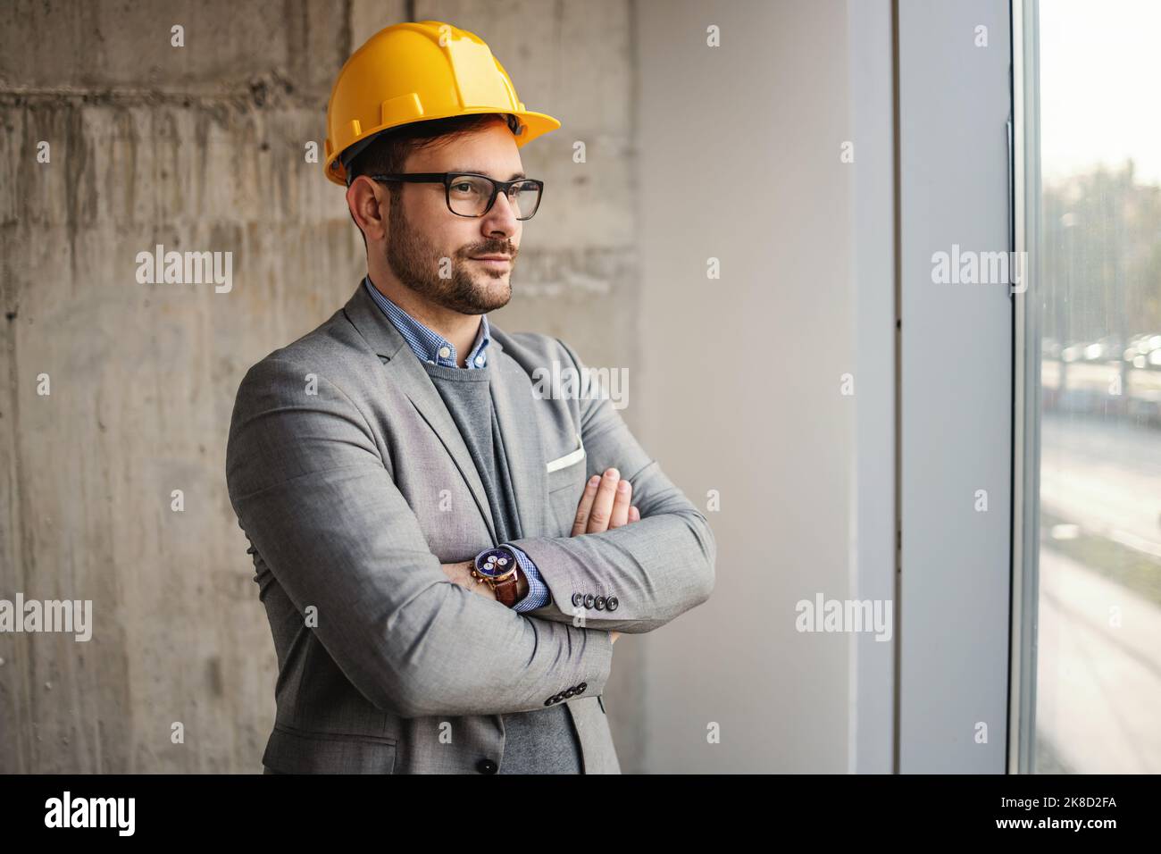 Successful architect standing in building in construction process with ...
