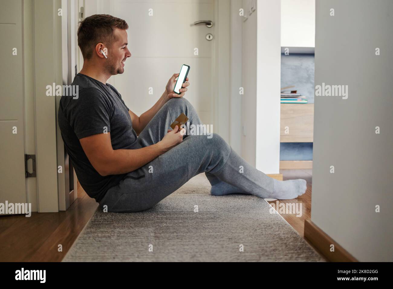 Online account verification. A casual man in a modern home sits on the ...