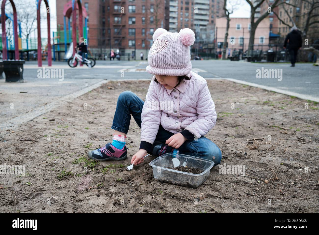 Girl digging in the dirt on the playground on a foggy fall day Stock ...