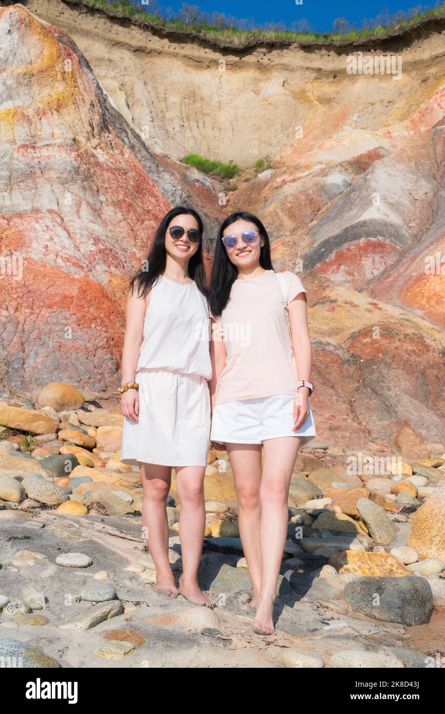 Two happy chinese women wearing sunglasses standing near Gayhead Cliffs ...