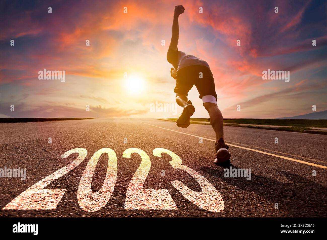Young man running and sprinting on the road with new year 2023 concept ...