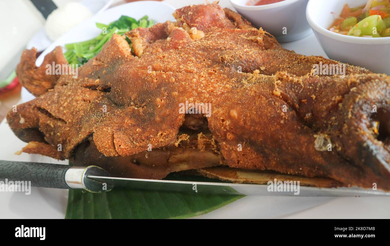 very tasty and delicious fried pork head Stock Photo - Alamy