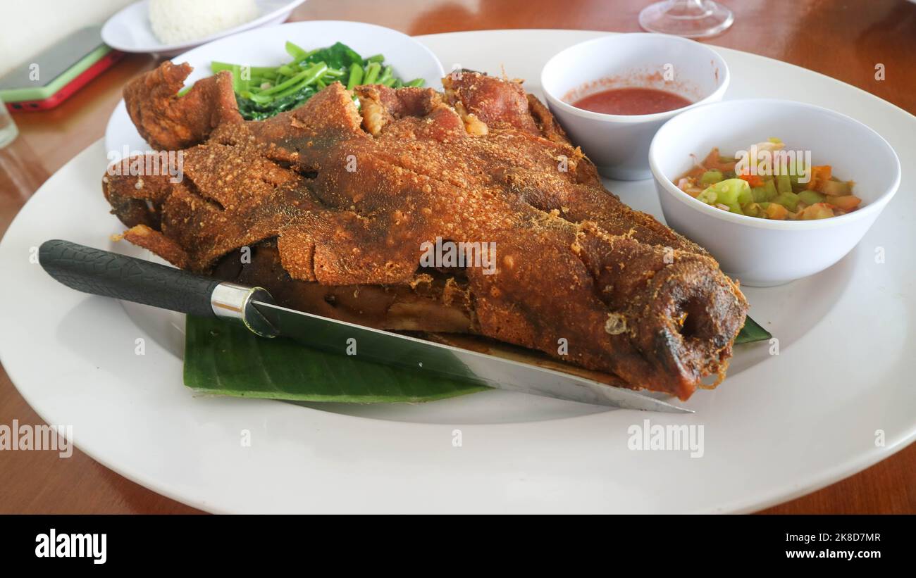 very tasty and delicious fried pork head Stock Photo - Alamy