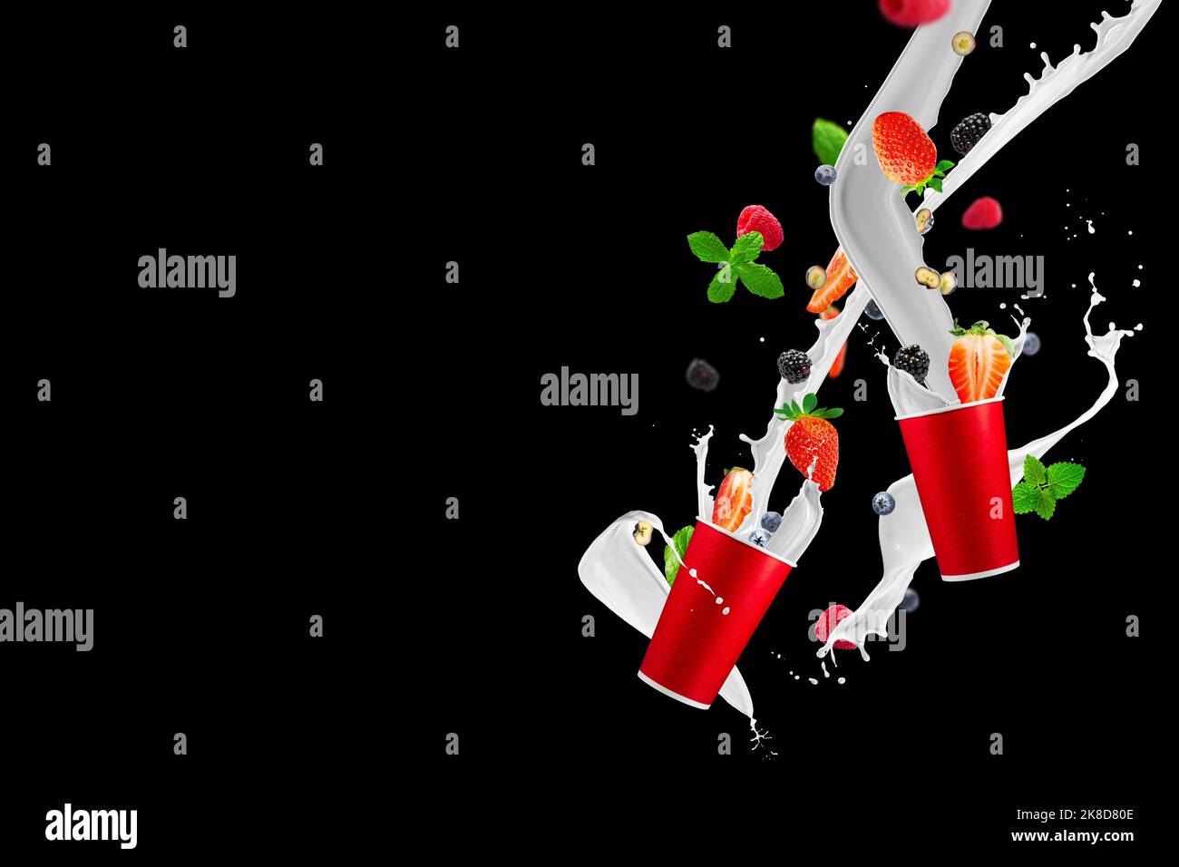 Strawberry milkshake. Paper takeaway cup with strawberry milk splashes ...