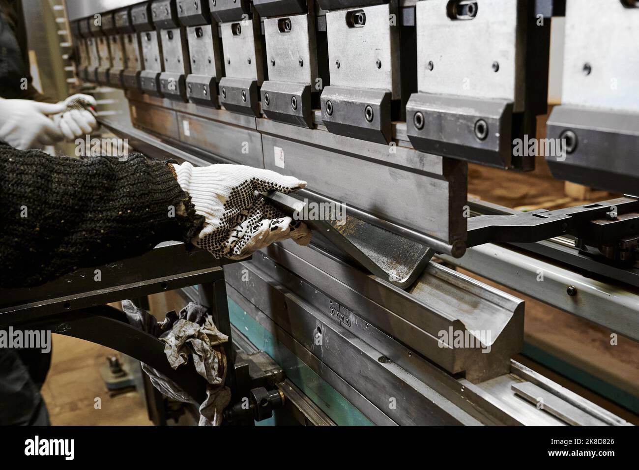 Bending press operates with metal sheet in plant workshop Stock Photo ...
