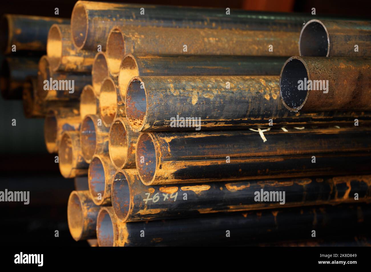 Bundle of rusty metal tubes in industrial complex storehouse Stock ...