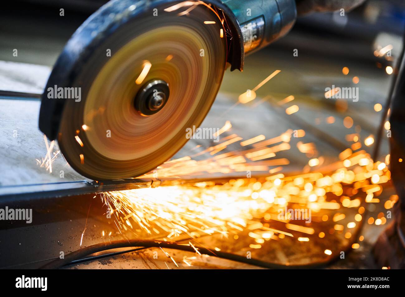 Metal plate cutting with abrasive disk and splashing sparks Stock Photo ...
