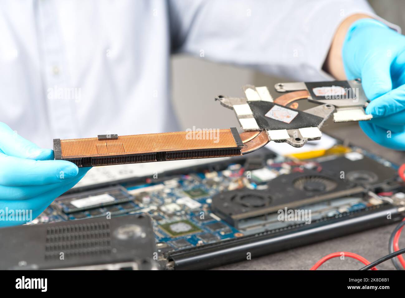 Hands fixing motherboard of pc or laptop notebook close up in service ...