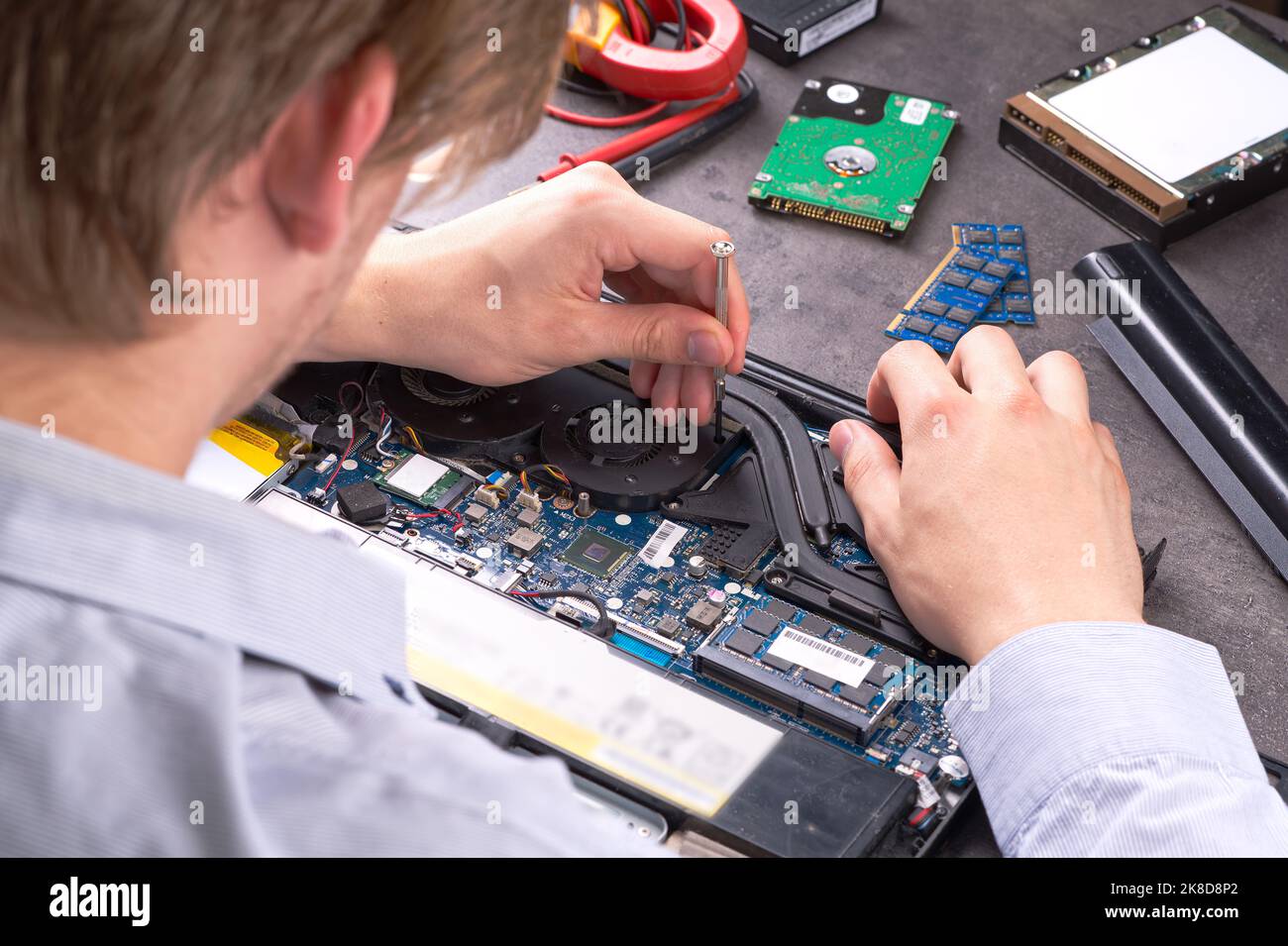 Hands fixing motherboard of pc or laptop notebook close up in service ...