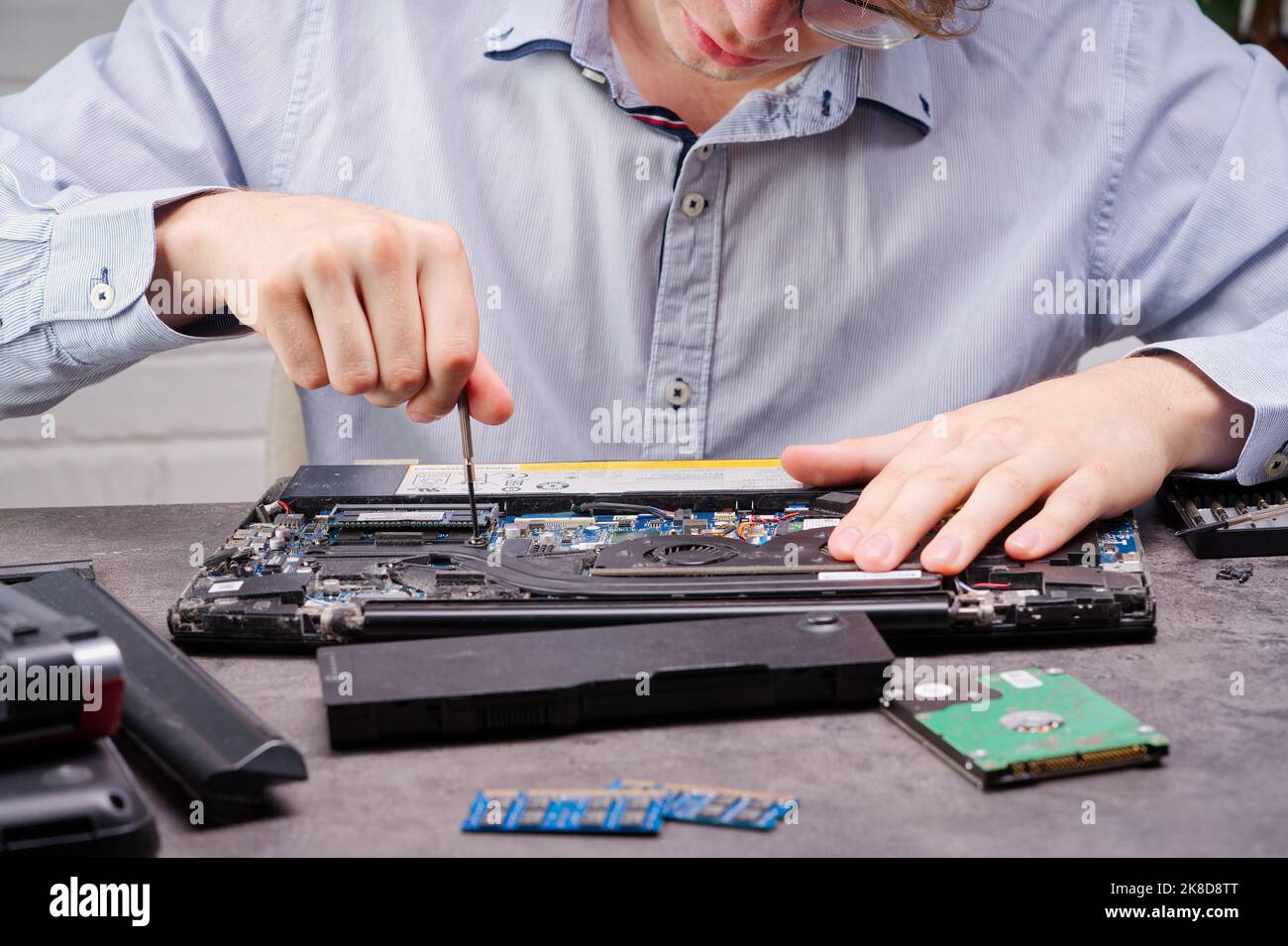 Man disassembles a laptop. Computer service and repair concept. Laptop ...