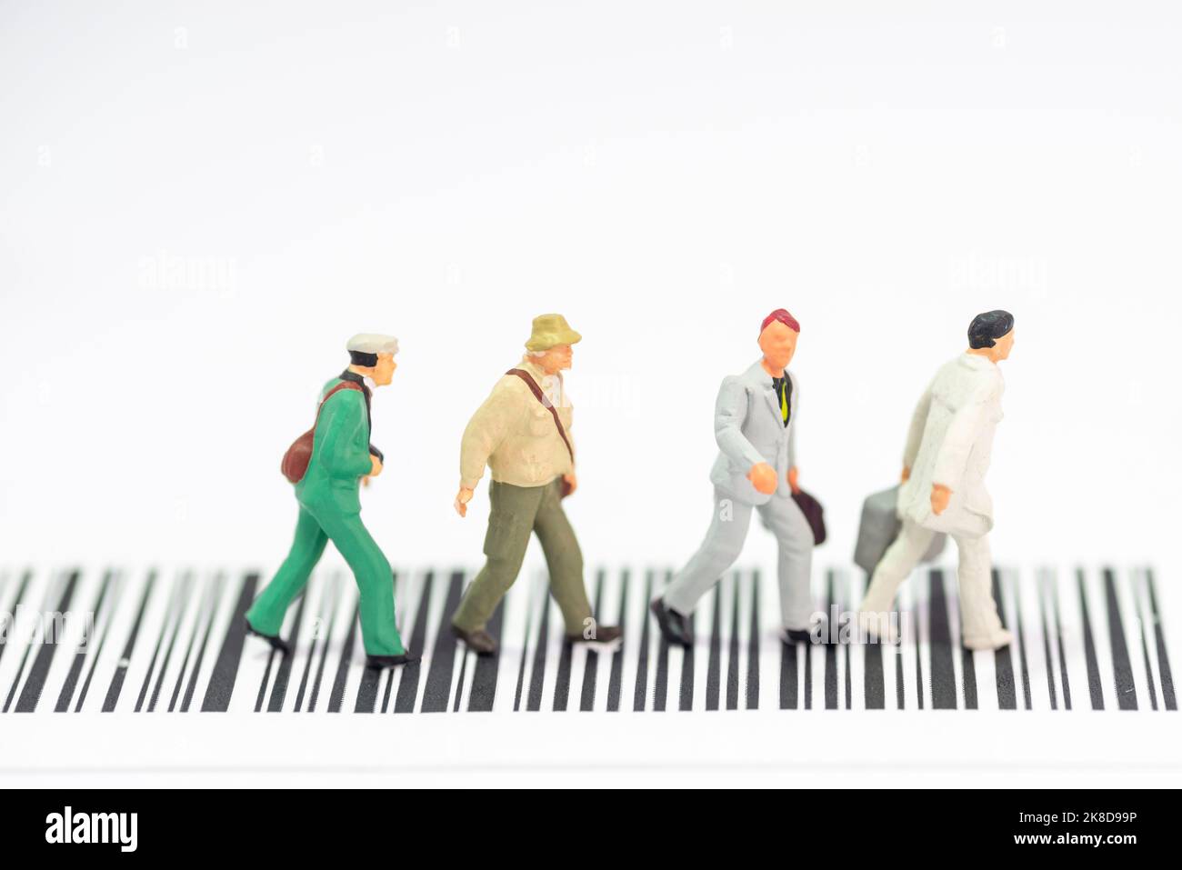 Miniature toys a group of people crossing a road - road safety concept ...