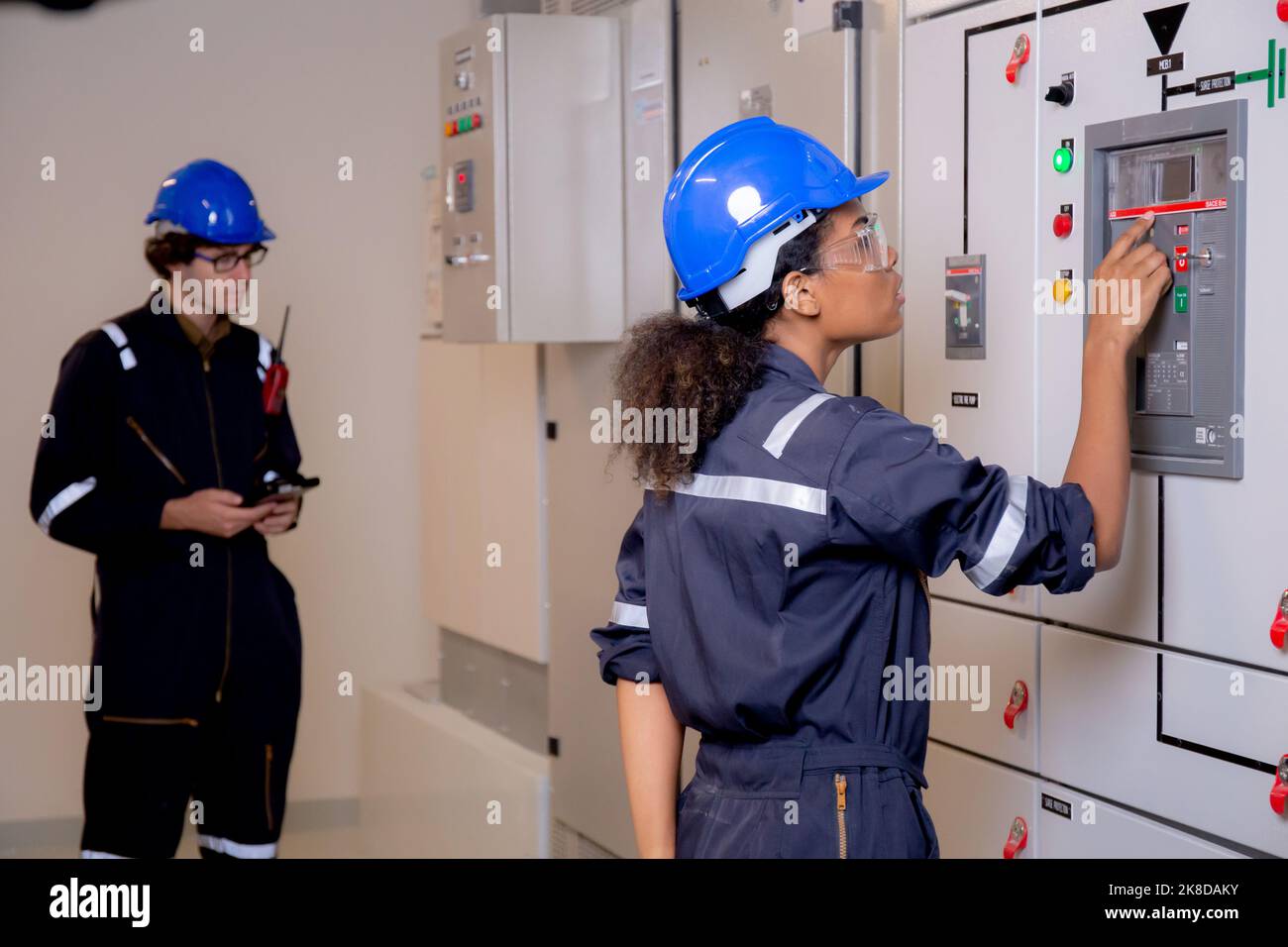 Electrical young asian woman and man engineer examining maintenance ...