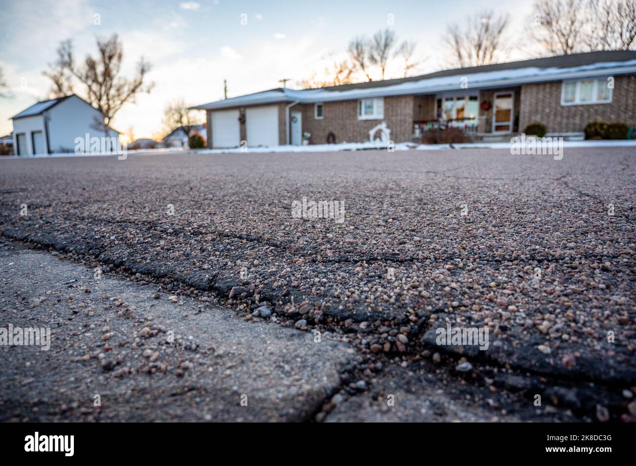 low angle selective focus on asphalt overlay paving on top of a ...