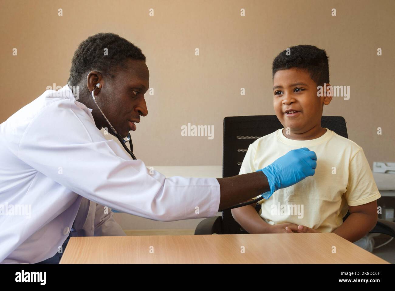 african american man pediatrician doctor using stethoscope to examining ...