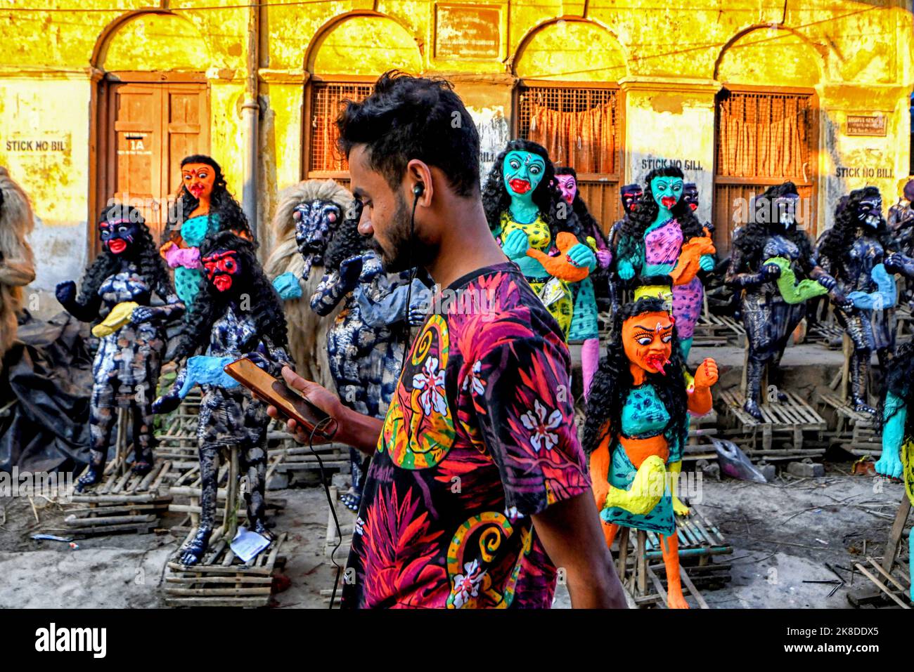 Kolkata, India. 22nd Oct, 2022. A man walks past big size demon clay ...