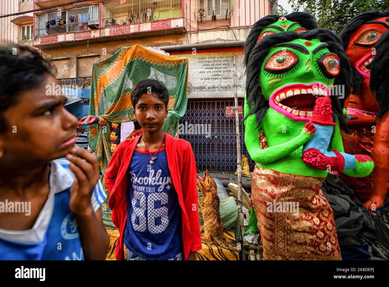 A young boy reacts towards an idol of the demon clay sculpture ahead of ...