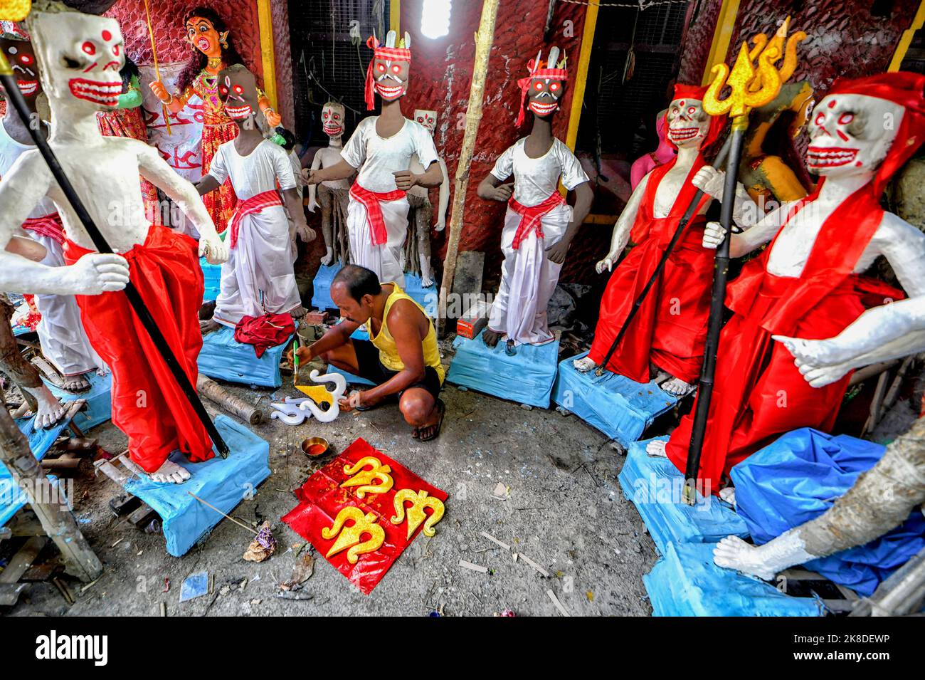 An artist makes final touches to the demon clay sculpture at Kumartuli ...