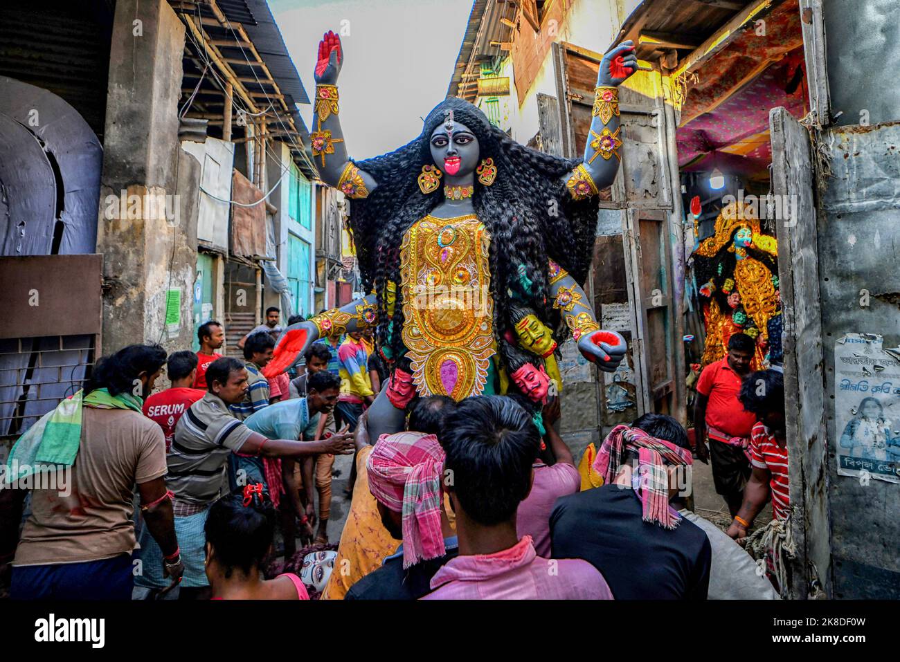 Porters carry an idol of Hindu goddess Kali ahead of the festival ...