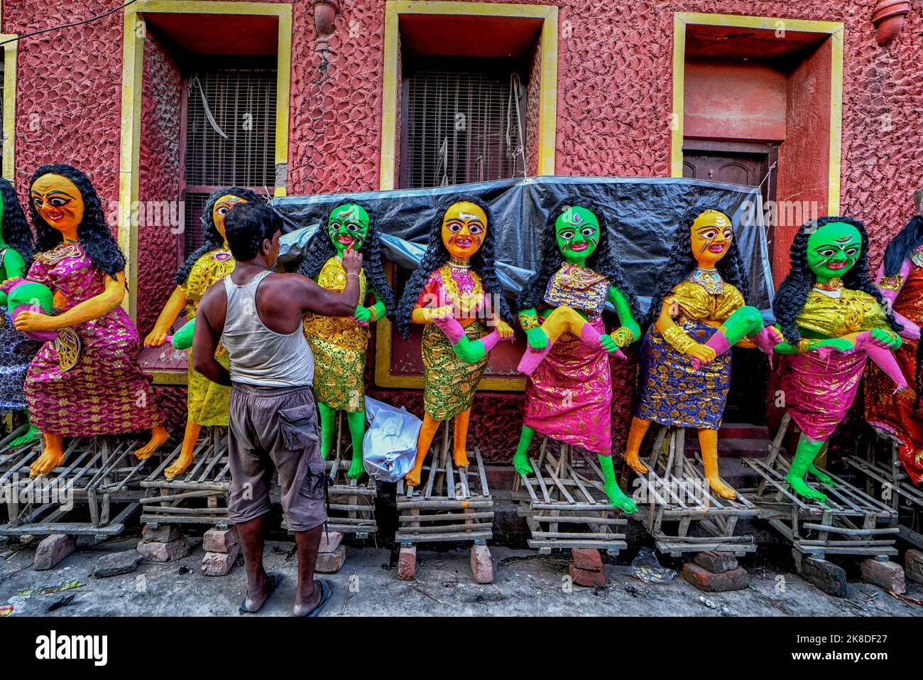 An artist makes final touches to the demon clay sculpture at Kumartuli ...