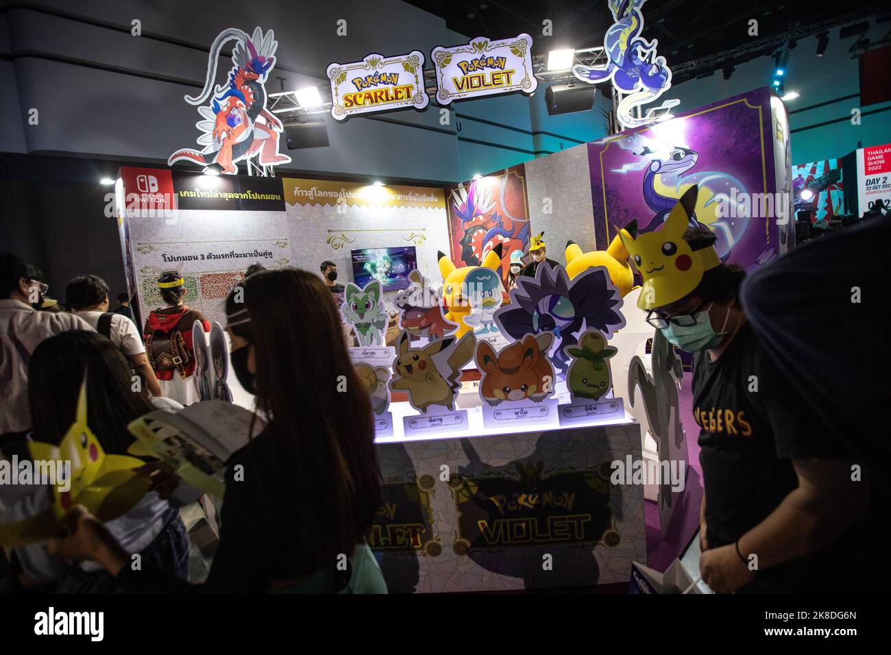 Visitors line up for their turn to take a picture with two Pikachu ...