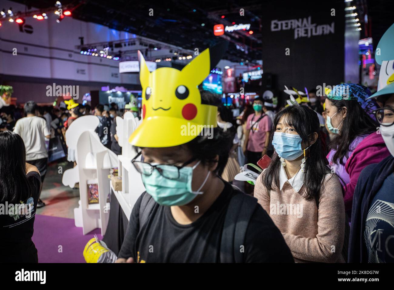 Visitors line up for their turn to take a picture with two Pikachu ...