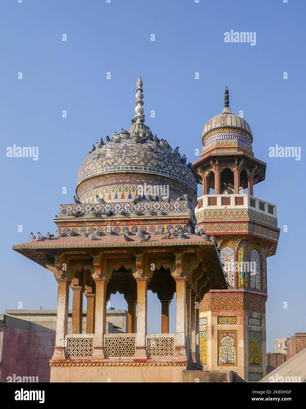 View of minaret and kiosk with pigeons seen from the roof of landmark ...