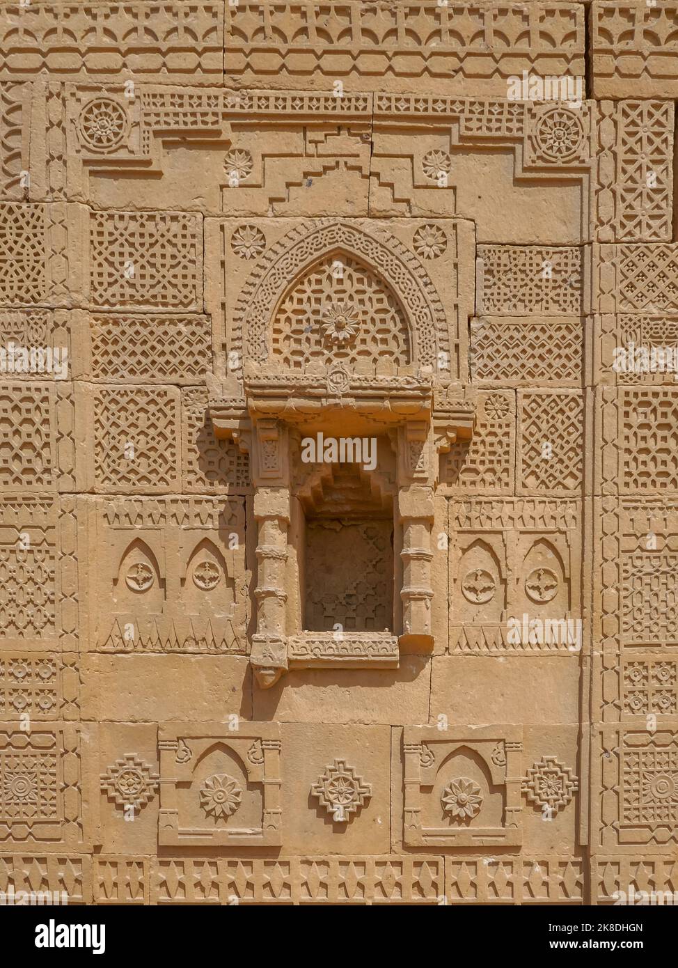 Traditional geometric and floral carved stone detail on outside wall of ...