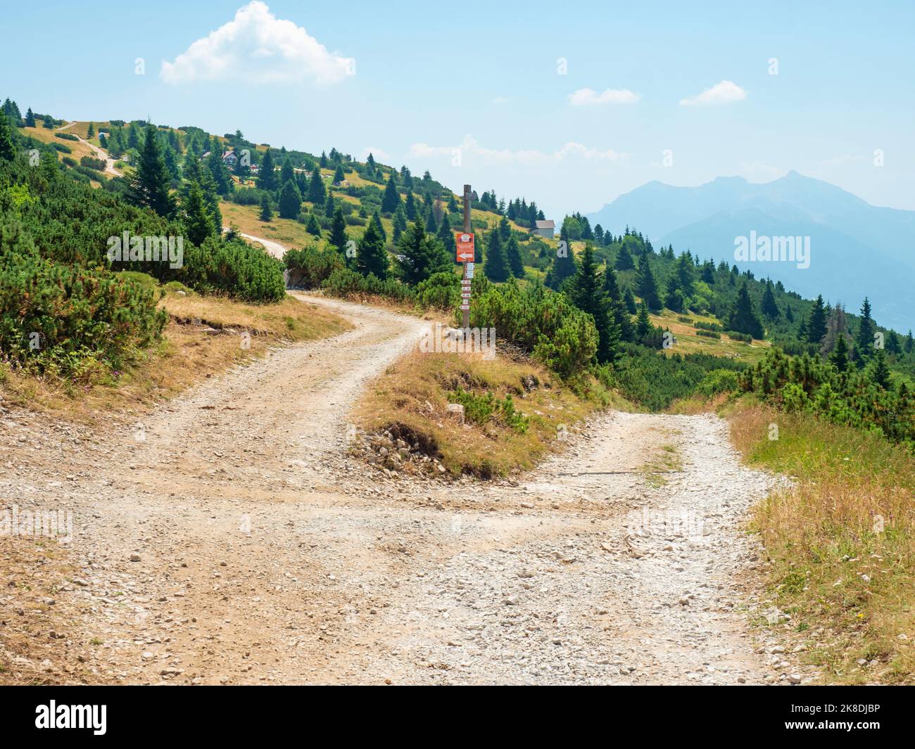 Gravel road to hill peak. Dusty mountain road in Dolomite Alps. Enjoy ...