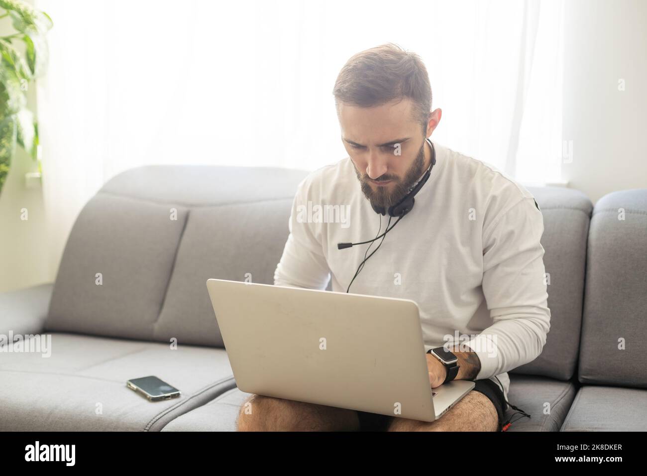 Man smiling working using computer laptop Stock Photo - Alamy