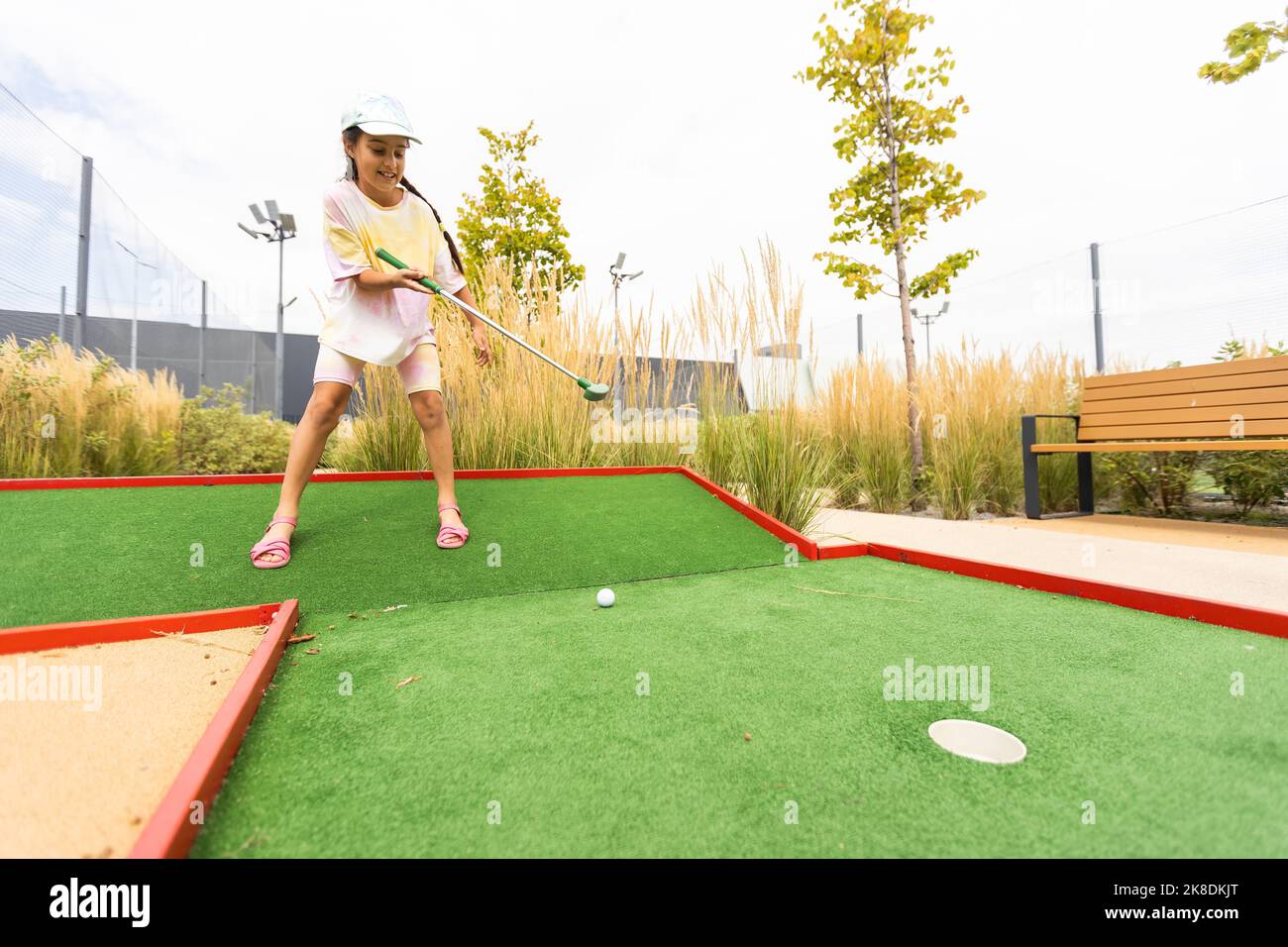 Beautiful little girl playing mini Golf Stock Photo - Alamy