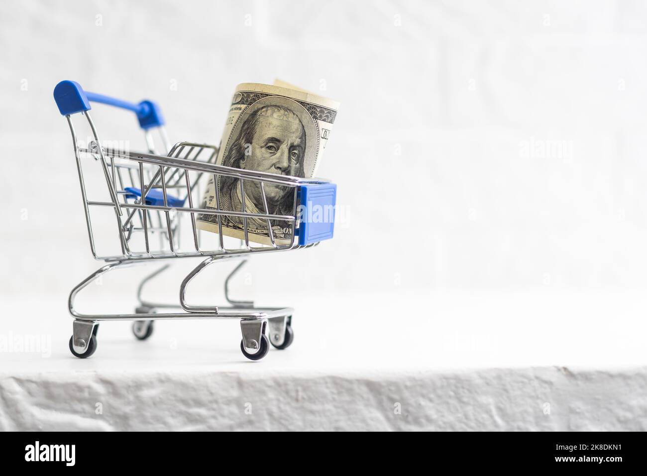 Small shopping trolley with dollars banknotes on white background Stock ...