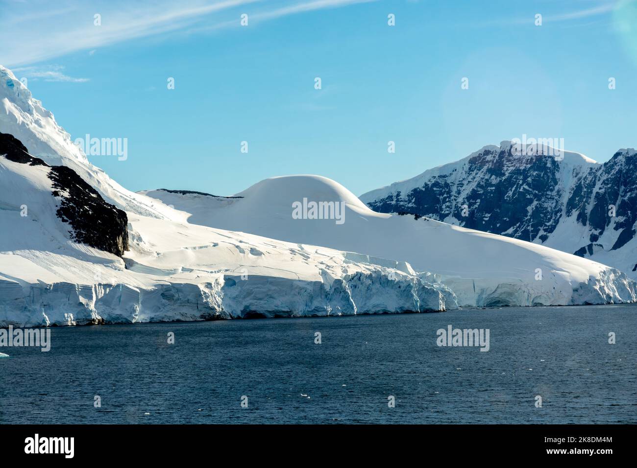 snow and ice covered peaks and shores of anvers island from neumayer ...