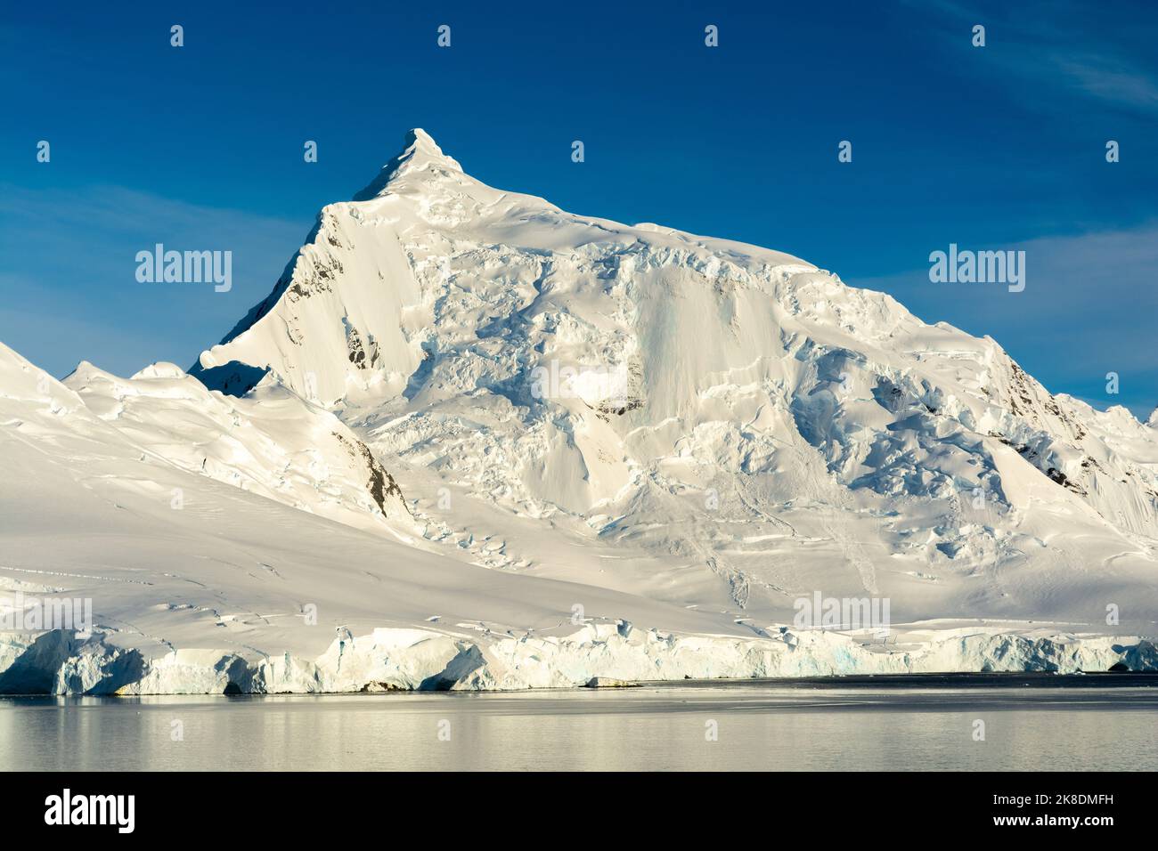 early morning sun lights up snow covered mt. william on anvers island ...