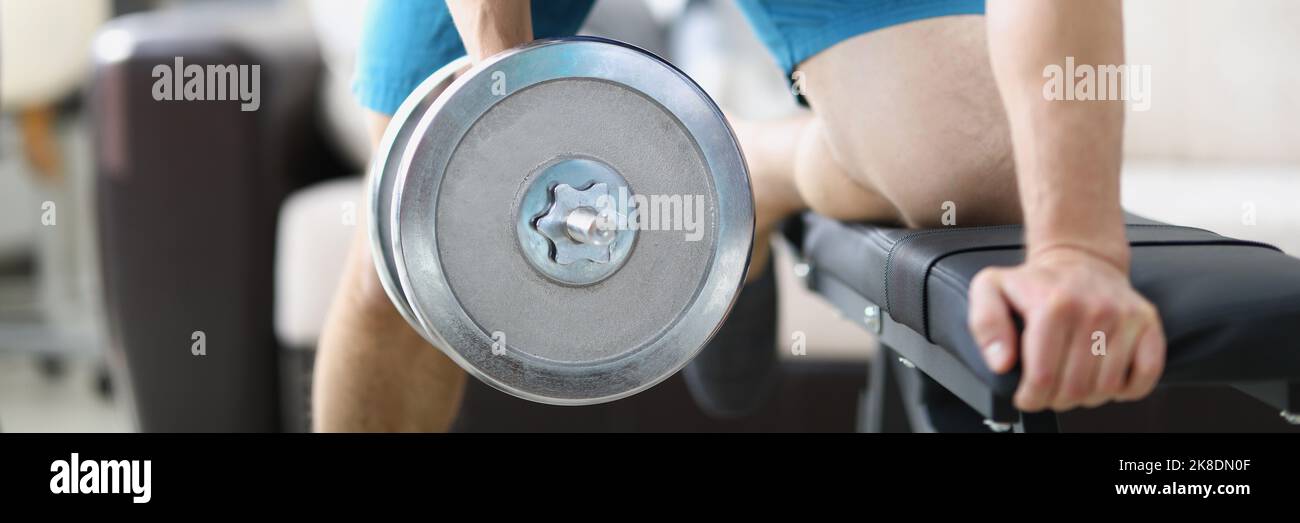Man lifting heavy dumbbell with one hand, train body and muscles ...