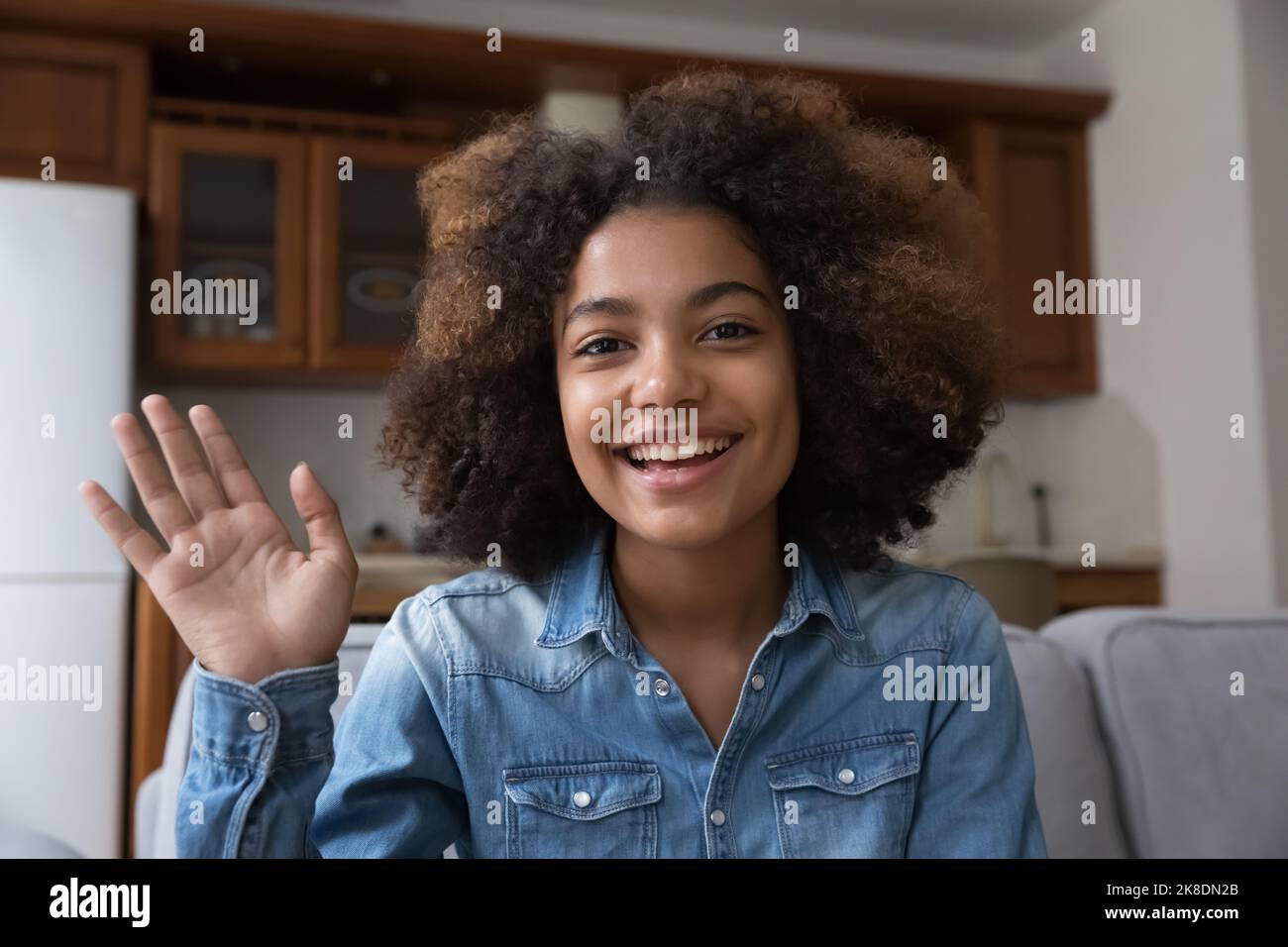 African teenager girl looks at camera start videocall Stock Photo - Alamy