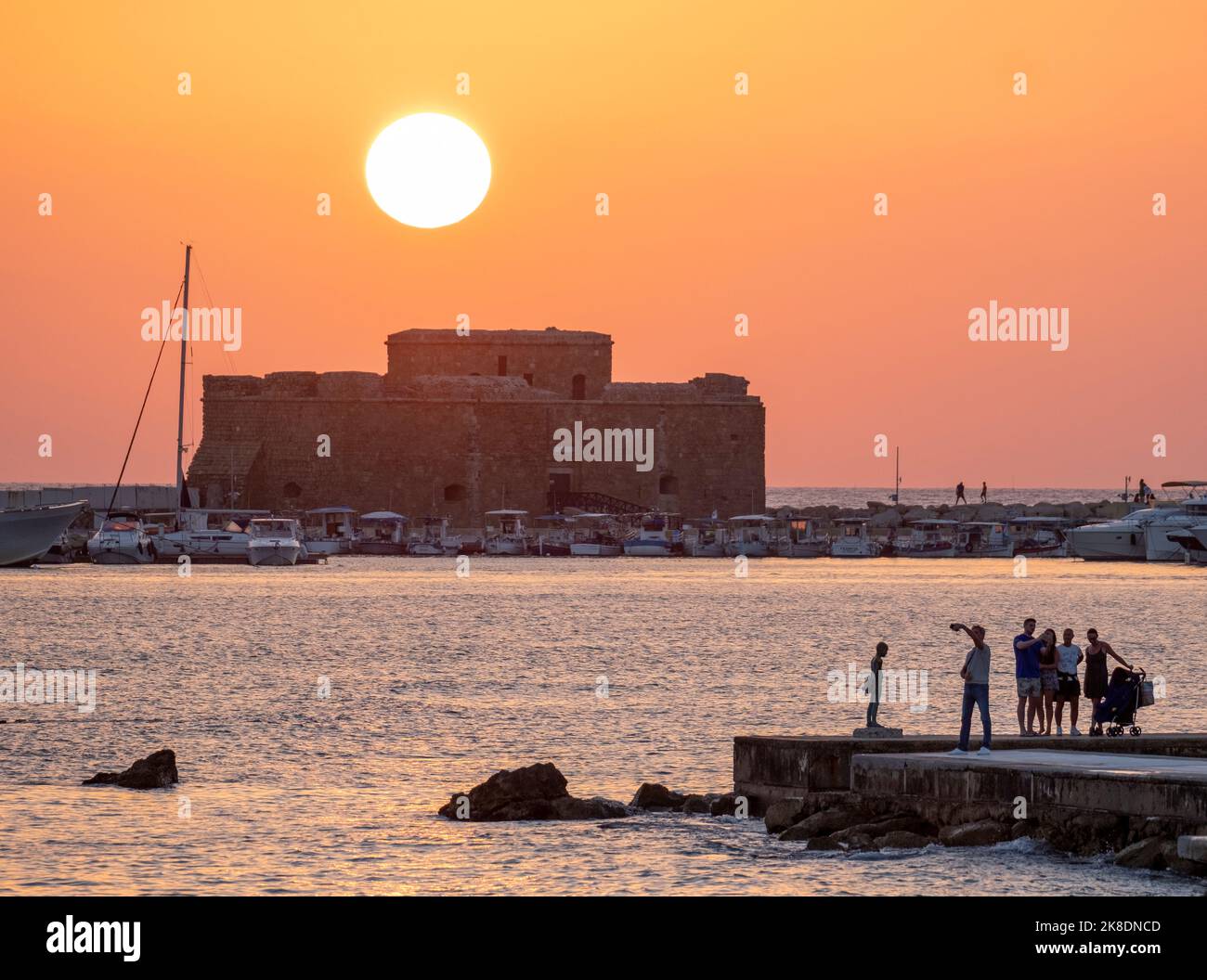 The sun sets over Pafos Fort, Pafos harbour, Cyprus Stock Photo - Alamy