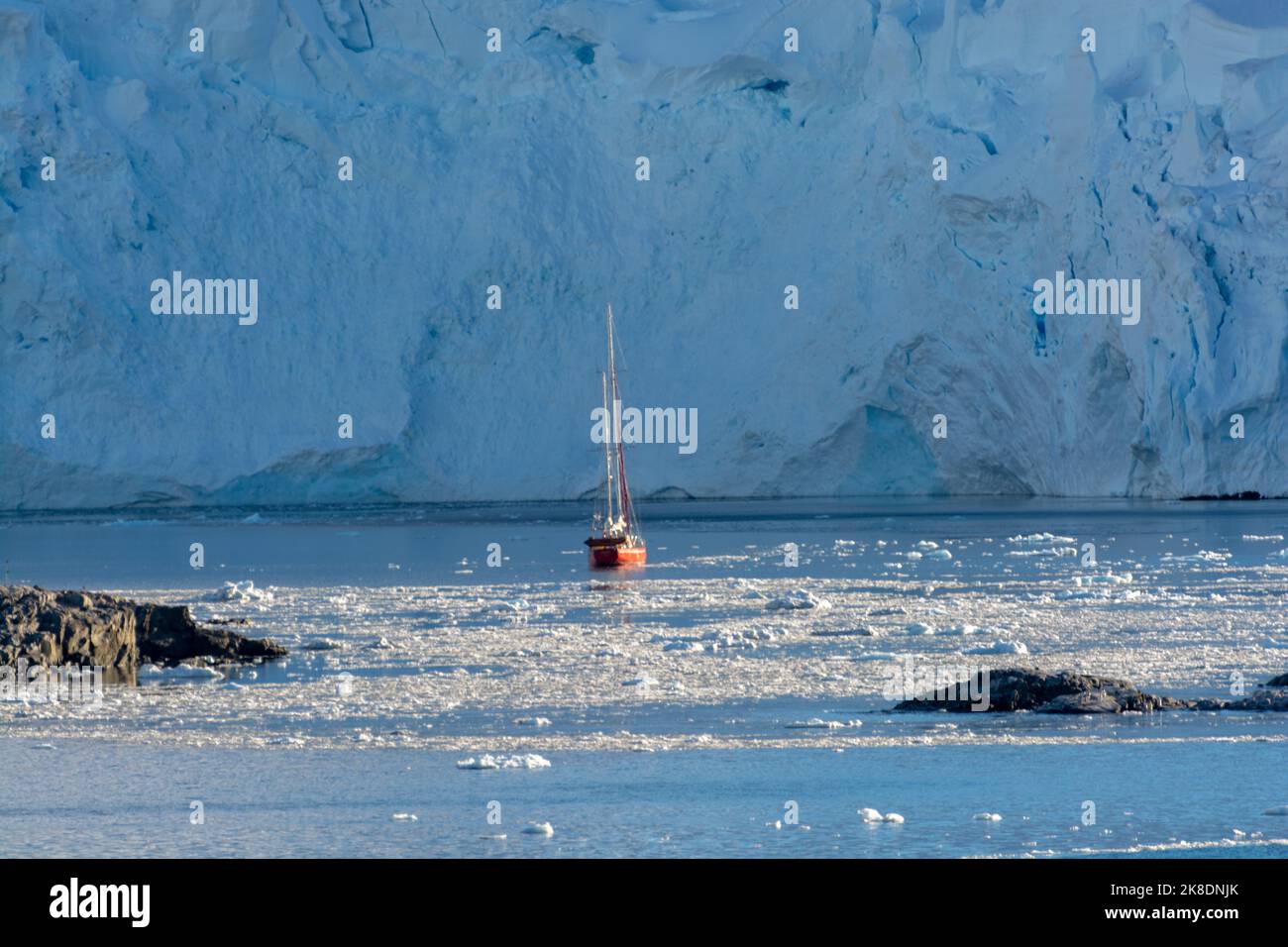 yacht moored in icy waters at port lockroy station on goudier island ...