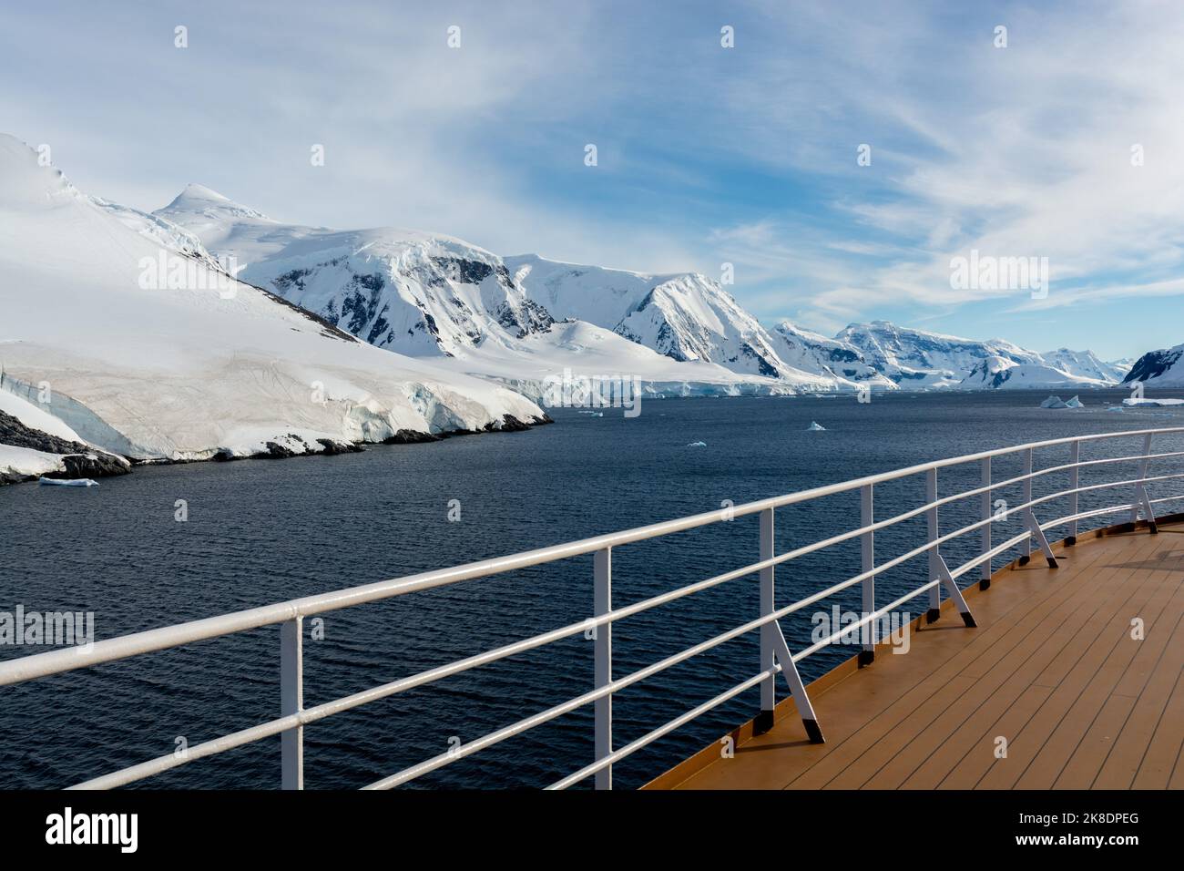 ice and snow covered peaks and shores of anvers island from deck of ...