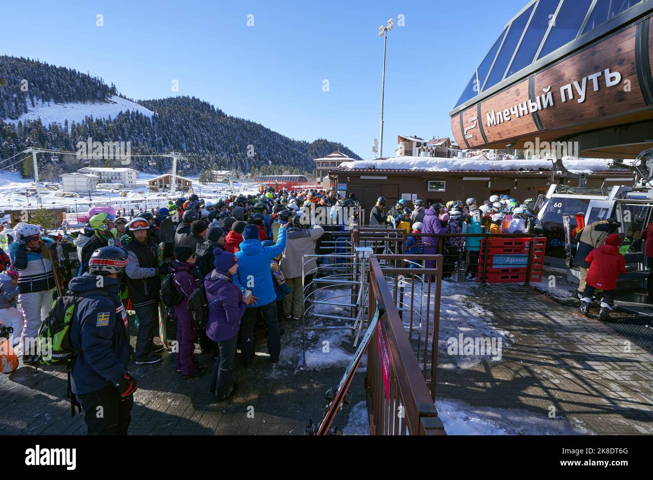 Crowd of people snowboarders and skiers in line to pass Stock Photo - Alamy