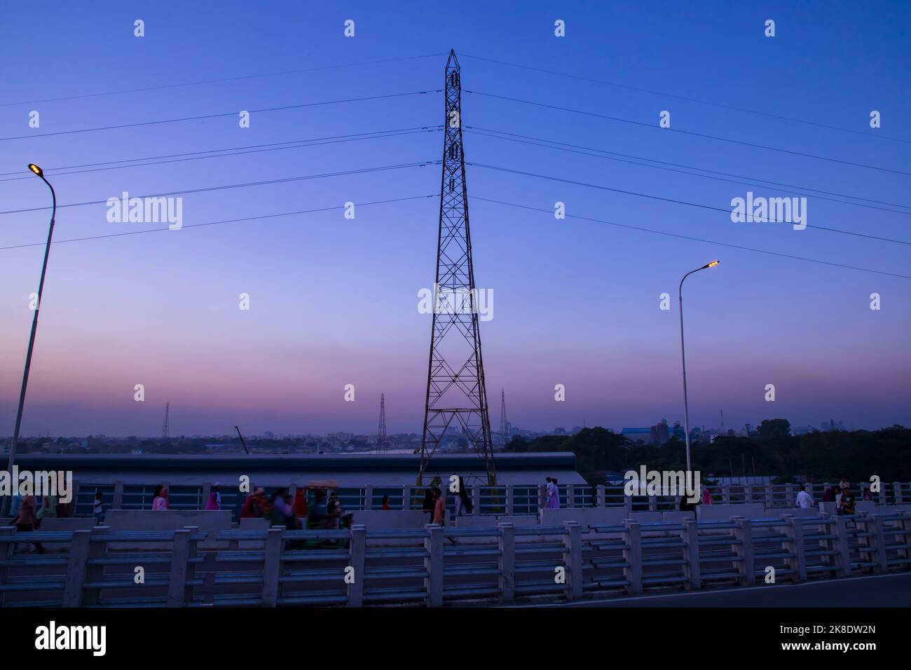 High Voltage electric pylons with colorful landscapes after sunset ...